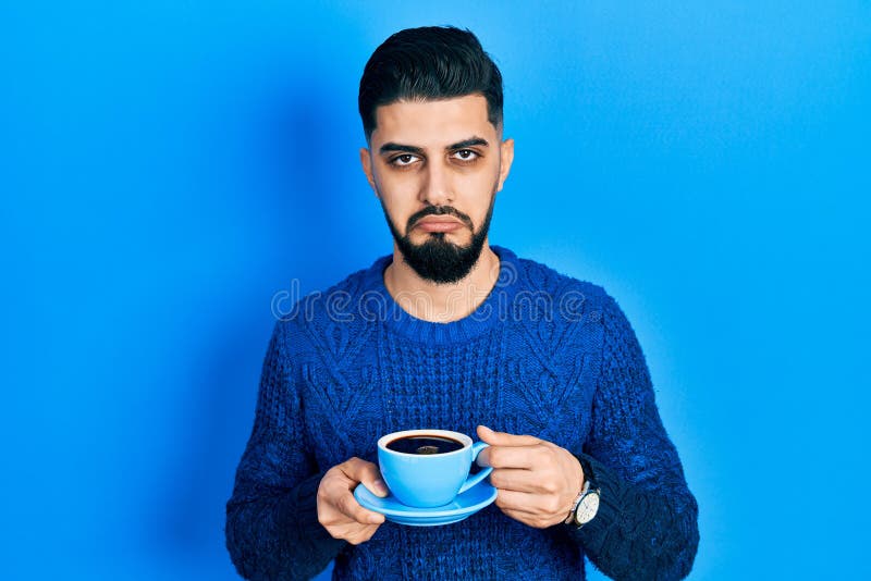 Handsome Man with Beard Drinking a Cup of Coffee Depressed and Worry ...