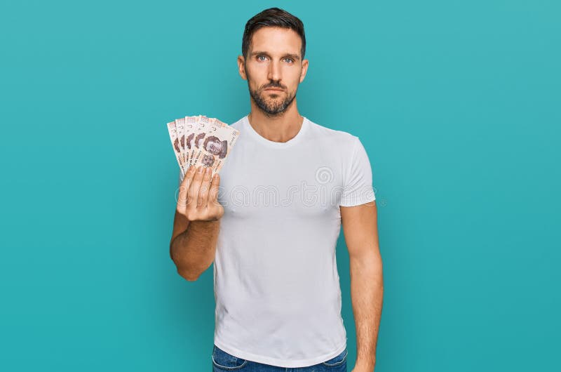 Handsome Man with Beard Holding 50 Mexican Pesos Banknotes Thinking ...