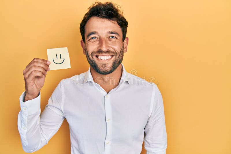 Handsome Man With Beard Holding Smile Emoji Reminder Looking Positive