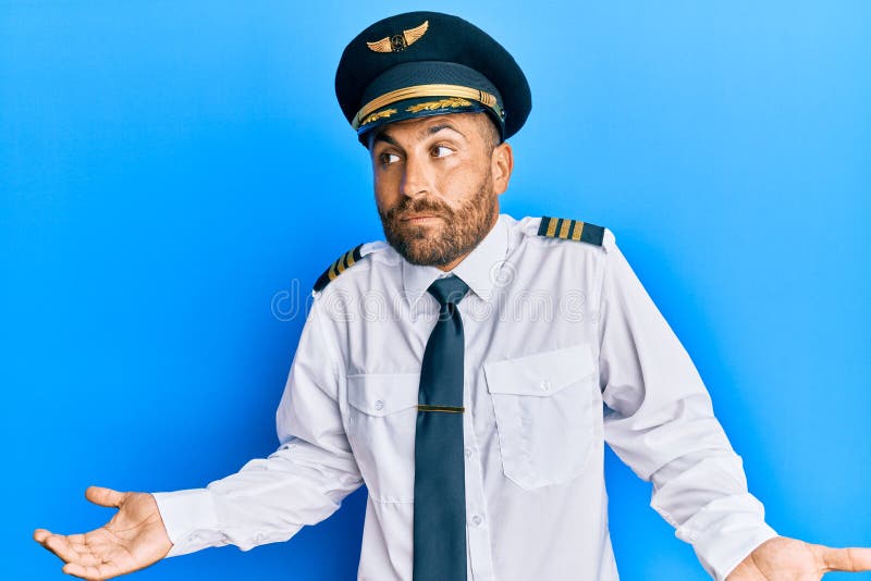Handsome Man With Beard Wearing Airplane Pilot Uniform Clueless And