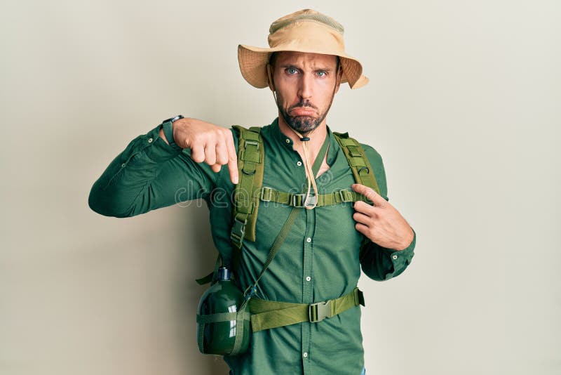 Handsome Man with Beard Wearing Explorer Hat and Backpack Pointing Down ...