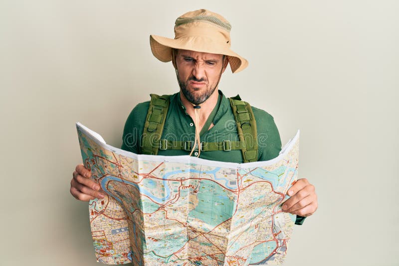 Handsome Man with Beard Wearing Explorer Hat Holding Map Clueless and ...