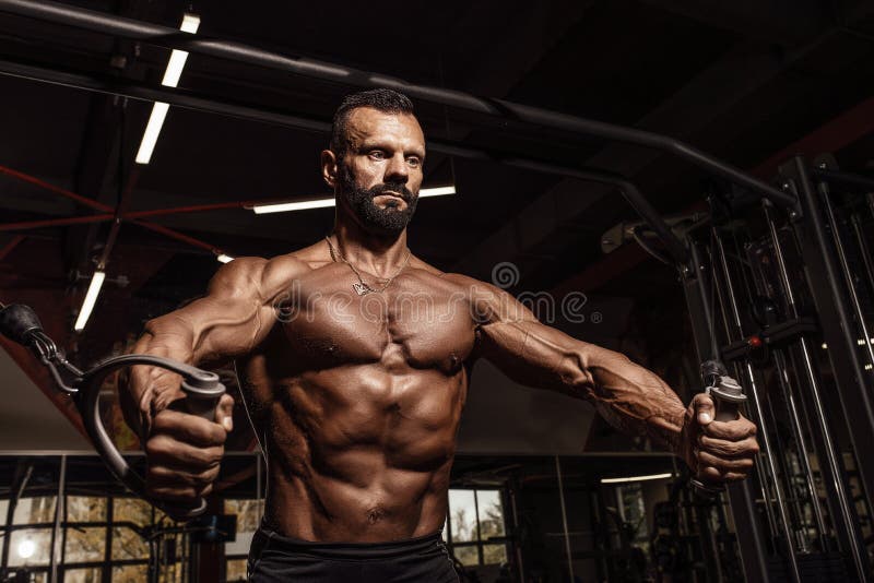 Handsome Man with Big Muscles Working Out in Gym. Muscular Bodybuilder ...