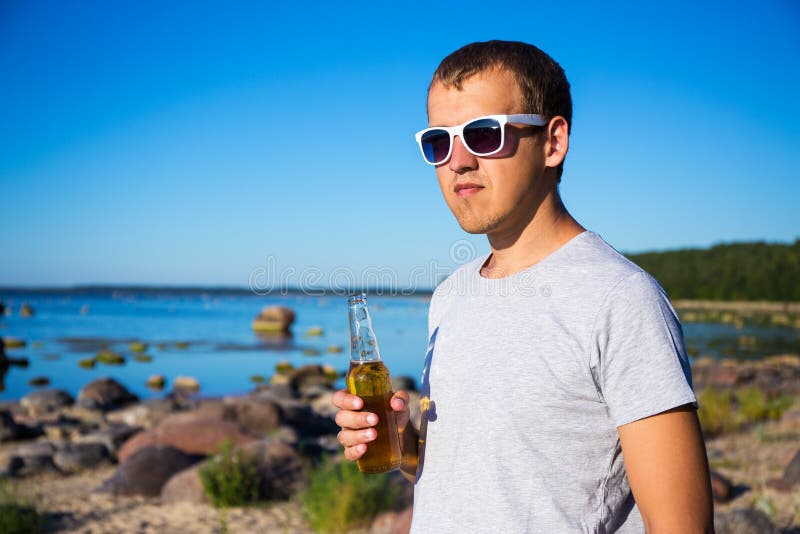 Handsome Man with Bottle of Beer on the Beach Stock Photo - Image of ...