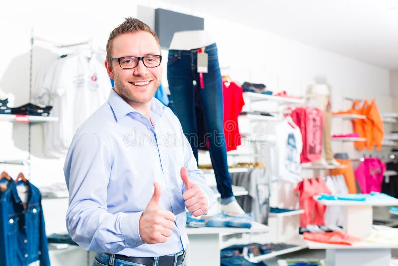 Male Sales Assistant in Clothing Store Stock Image - Image of counter ...