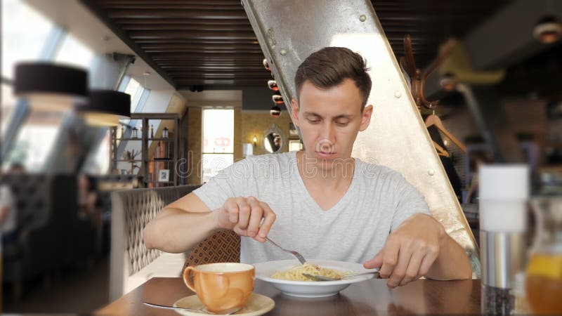 Man Eating Pasta with Sauce Bolognese in a Beach Cafe. High Italian ...