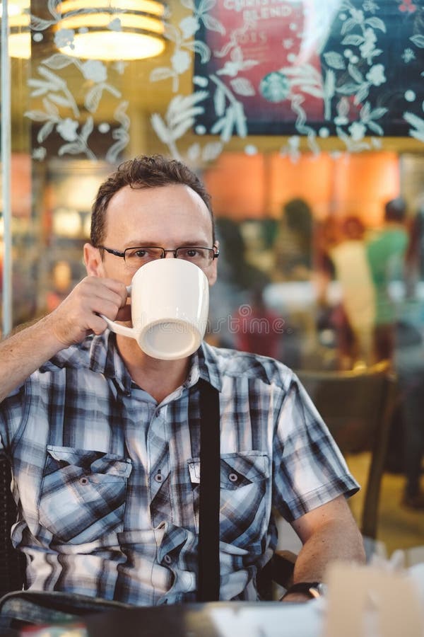 Handsome Man in a Cafe Outside Drinking Coffee Stock Image - Image of ...