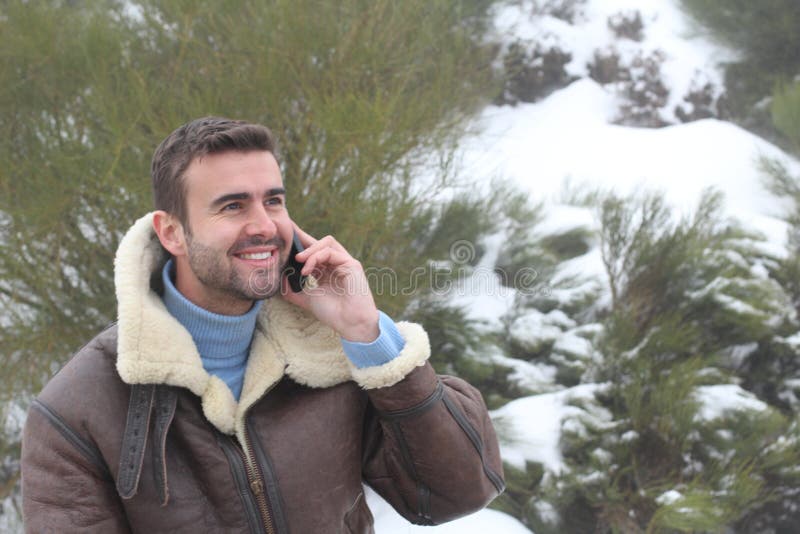 Handsome Man Calling by Phone Outdoors in the Winter with Copy Space ...