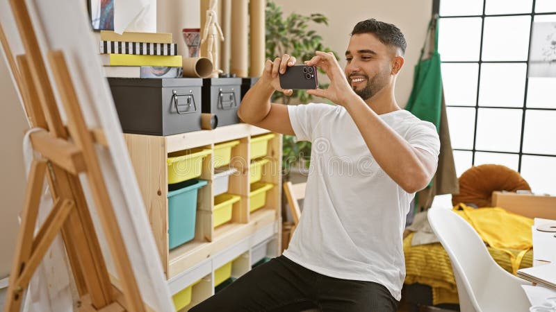 A Handsome Man Capturing Photo of His Artwork with a Smartphone in a ...