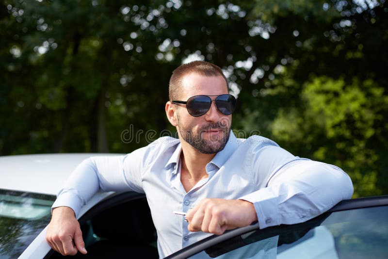 Handsome man with car stock image. Image of sunglasses - 58690711