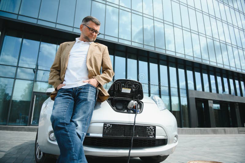 Man Charging His Electric Car at Charge Station Stock Photo - Image of ...