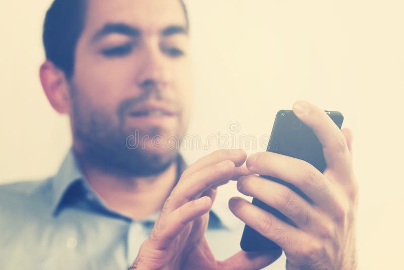 Handsome Man Checking His Phone Stock Photo - Image of examining ...