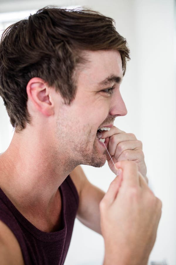 Handsome Man Cleaning His Teeth Stock Photo - Image of indoors ...