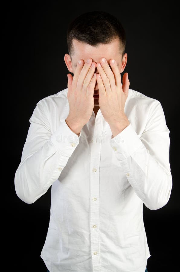 Young Handsome Guy Covers His Face with His Hands. Stock Photo - Image ...