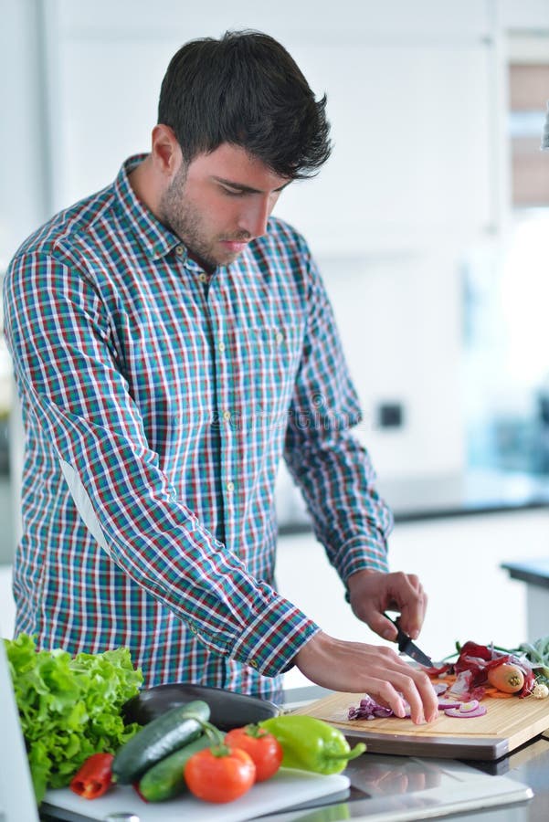 Handsome Man Cooking at Home Preparing Salad in Kitchen. Stock Image ...