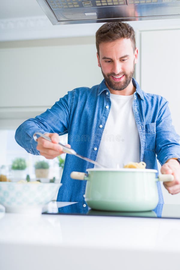 Handsome Man Cooking Pasta at Home Stock Image - Image of eating ...
