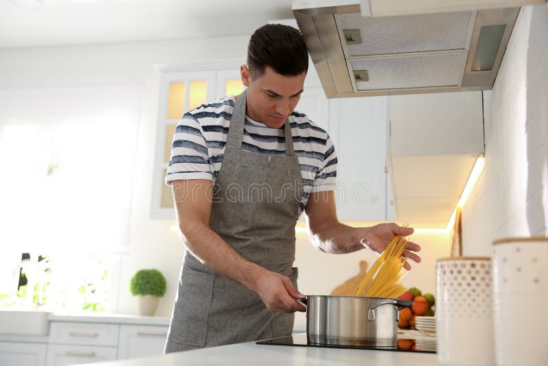 Handsome Man Cooking Pasta on Stove Stock Photo - Image of dish, meal ...