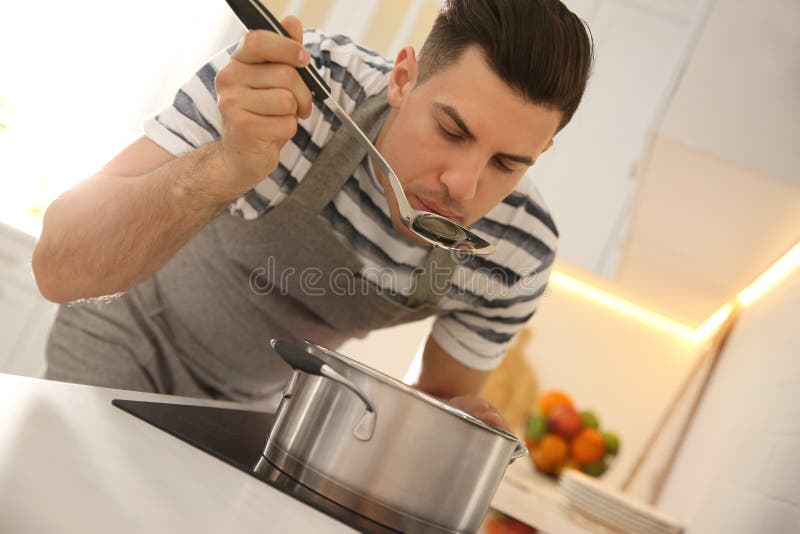 Handsome Man Cooking on Stove Stock Image - Image of ingredient ...