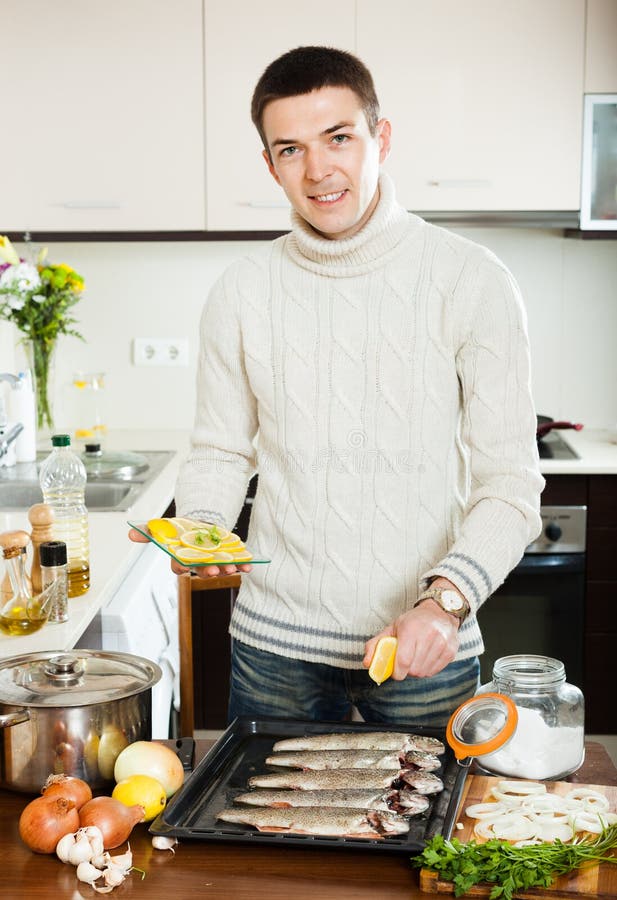 Handsome Man Cooking Trout Fish with Lemon Stock Photo - Image of ...