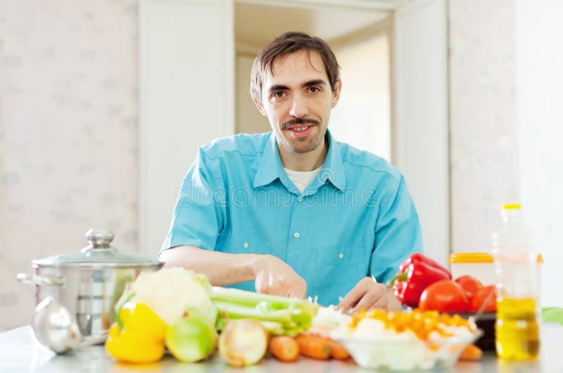 Handsome Man Cooking French-style Meat. Adding Grating Cheese Stock ...