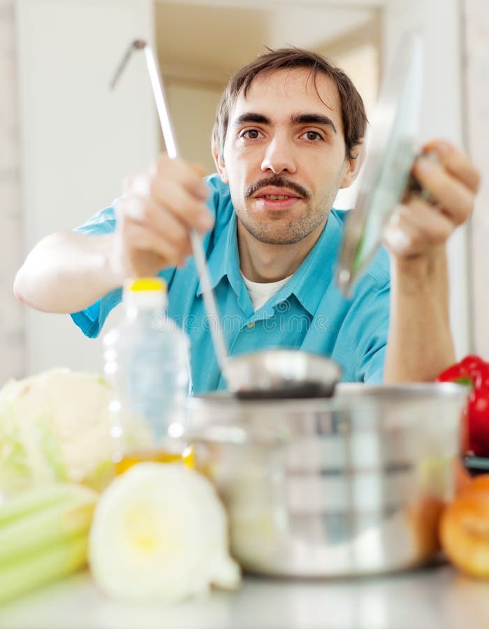Handsome man cooks lunch stock image. Image of caucasian - 33520227
