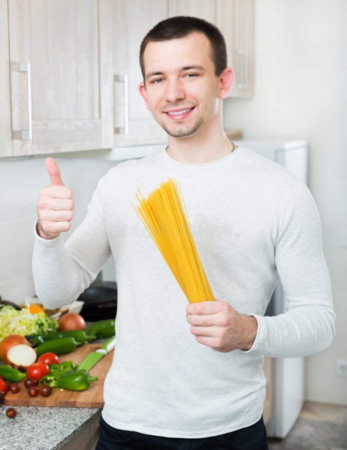 Handsome Man Cooks Spaghetti Stock Photo - Image of domestic, leisure ...