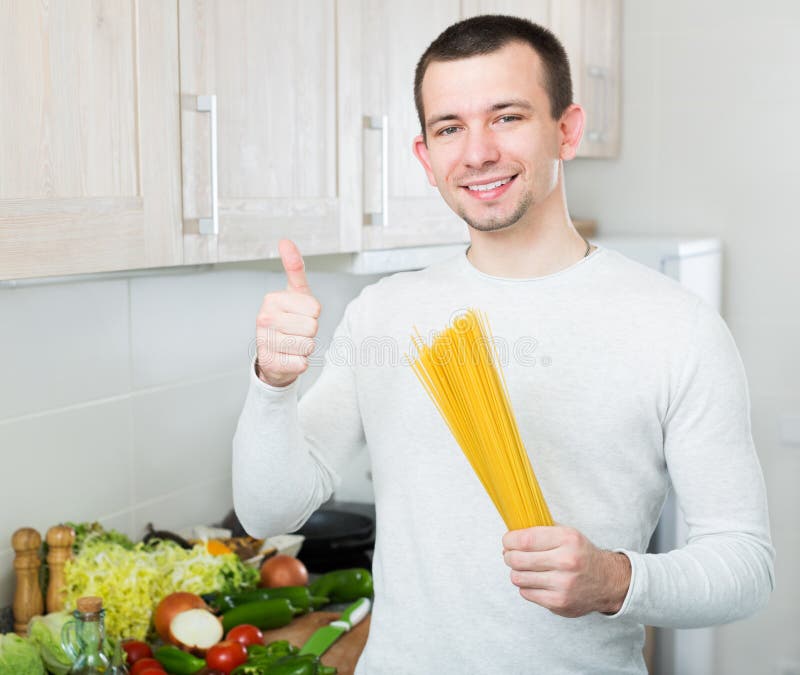 Handsome Man Cooks Spaghetti Stock Image - Image of groceries, kitchen ...