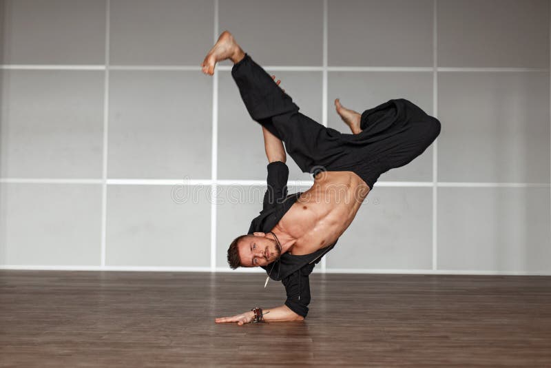 Handsome Man Dancer Dancing. Man Stands on Hands in a Dance Stock Photo ...