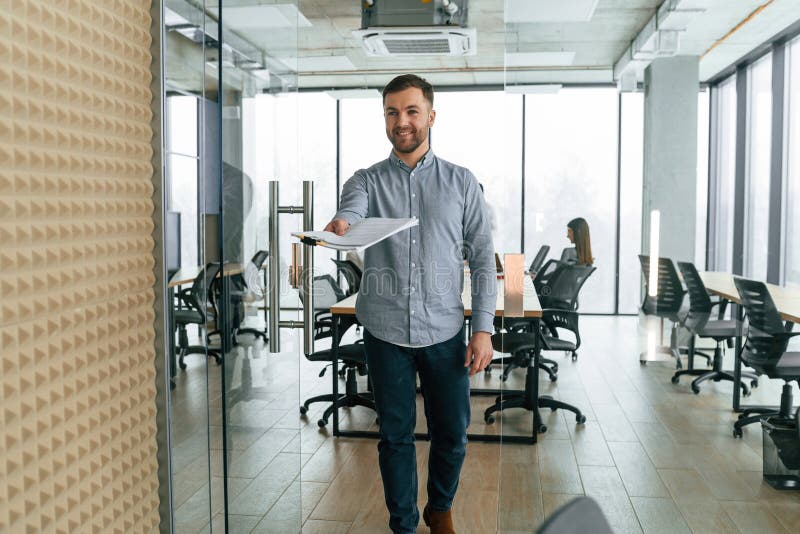 Handsome Man with Documents. Team of Office Workers are Together ...