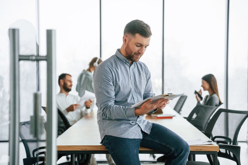 Handsome Man with Documents. Team of Office Workers are Together ...