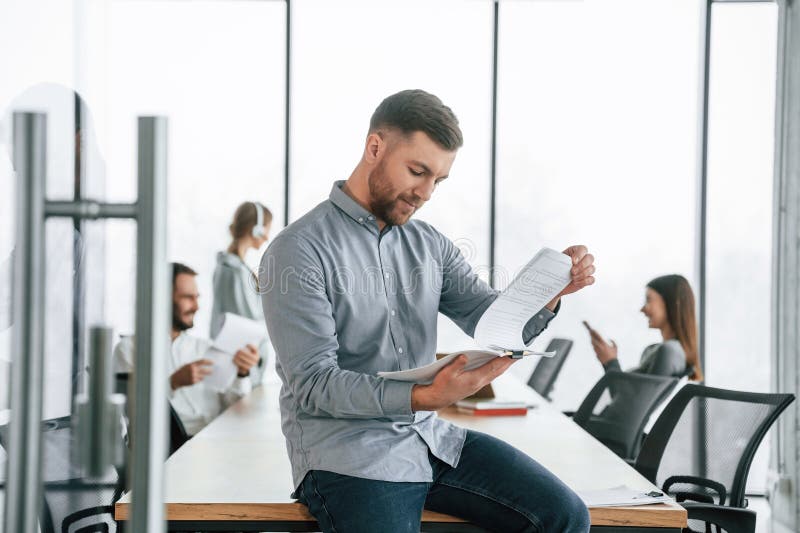 Handsome Man with Documents. Team of Office Workers are Together ...