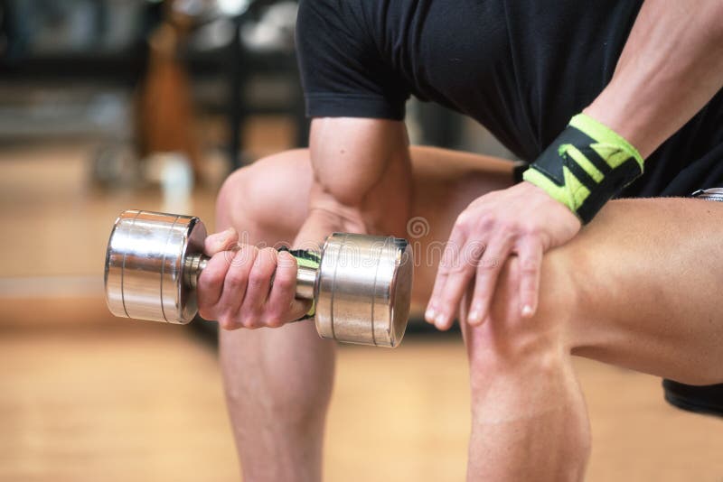 Handsome Man Doing Biceps Lifting with Dumbbell on Bench in a Gym ...