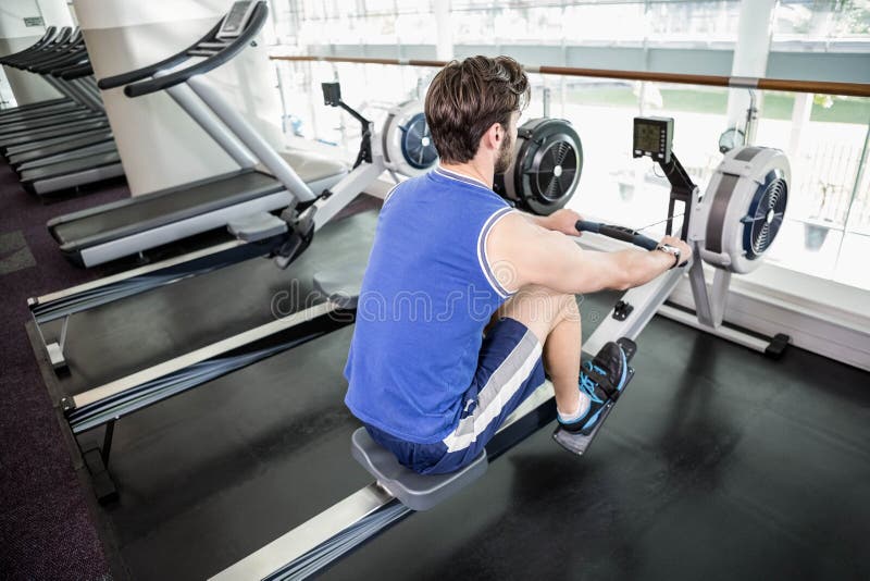 Handsome Man Doing Exercise on Drawing Machine Stock Image - Image of ...