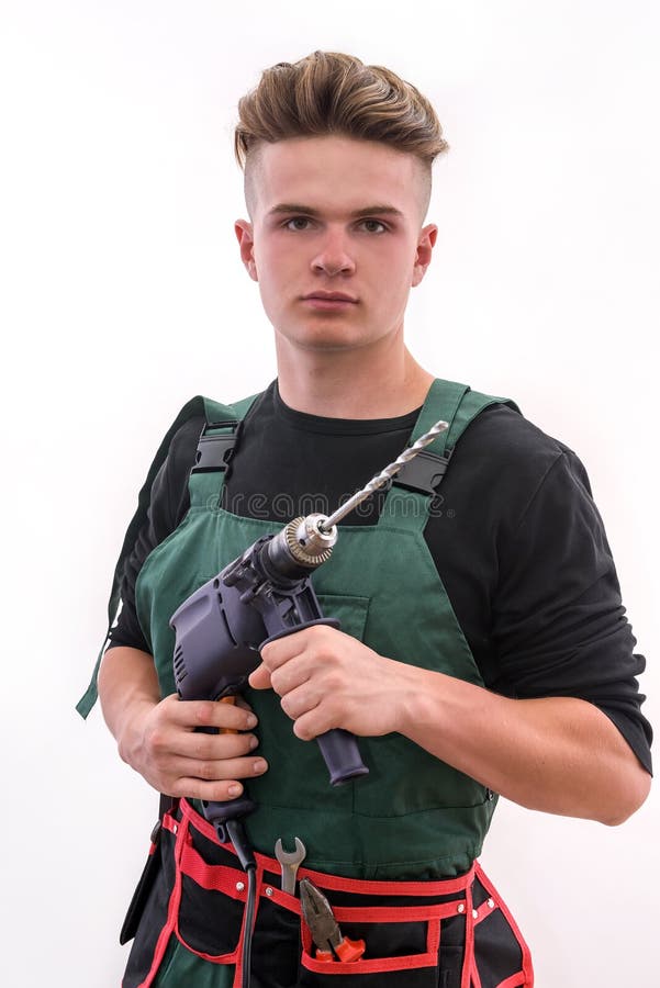 Handsome Man with Drill Machine Posing Isolated on White. Worker in ...