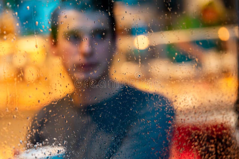 Handsome Man Drinking Tea or Coffee on Rainy Day and Looking through ...