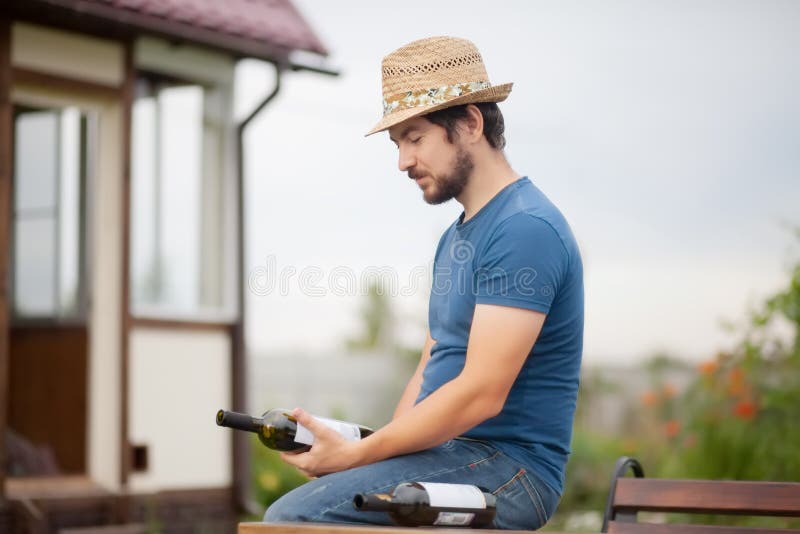 Handsome Man Drinking Vine from the Bottle at the Backyard of His Home ...