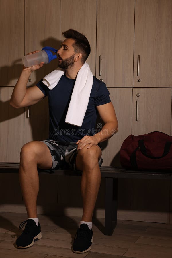 Handsome Man Drinking Water in Locker Room Stock Photo - Image of ...