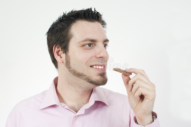 Handsome Man Eating a Chocolate Stock Photo - Image of handsome ...