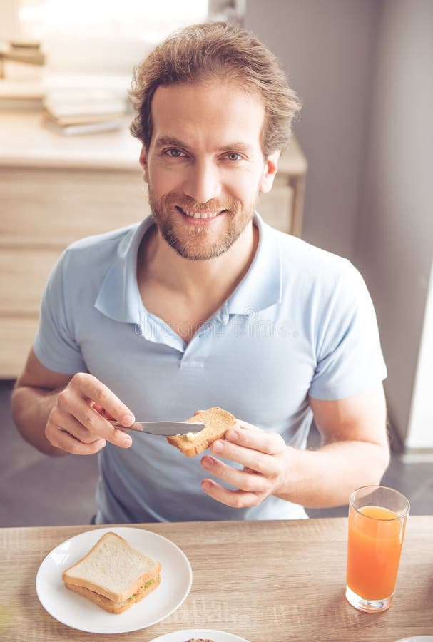 Handsome man eating stock image. Image of orange, little - 81350517