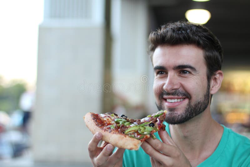Handsome man eating pizza stock photo. Image of male - 51756340