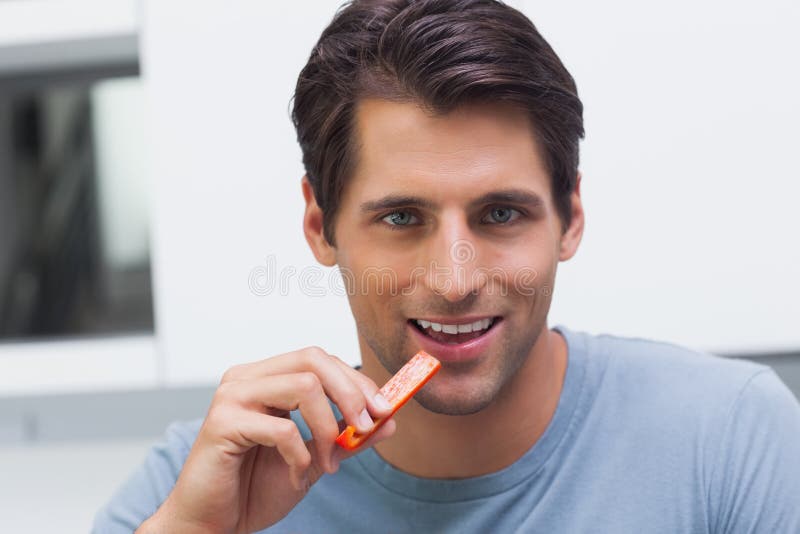 Handsome Man Eating a Slice of Bell Pepper Stock Photo - Image of ...