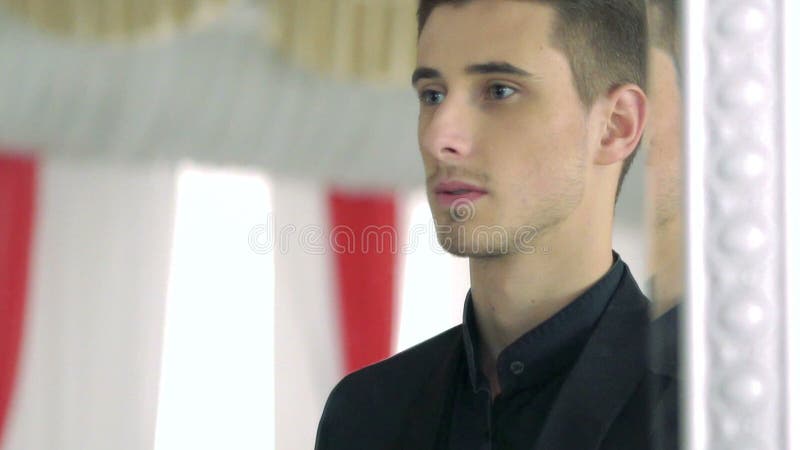 Handsome Man in Elegant Suit Looking at Himself in the Mirror. Slow ...