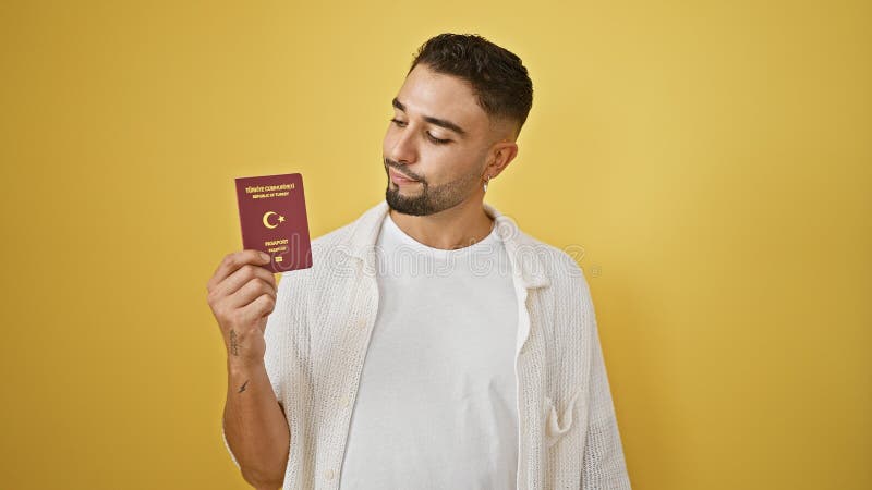 Handsome Man Examining Turkish Passport Against Yellow Wall Stock Photo ...
