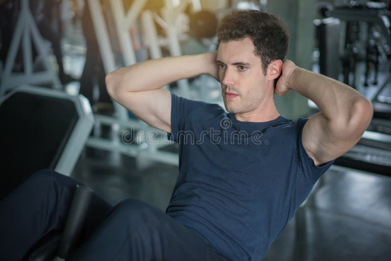 Handsome Man Exercising Doing Sit Up Abdominal Exercise in Gym Stock ...