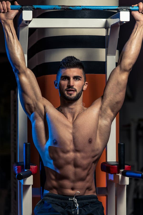 Handsome Man Exercising His Abs at the Gym Stock Image - Image of hang ...