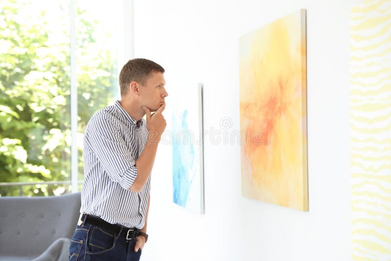 Handsome man at exhibition stock image. Image of artistic - 122876539