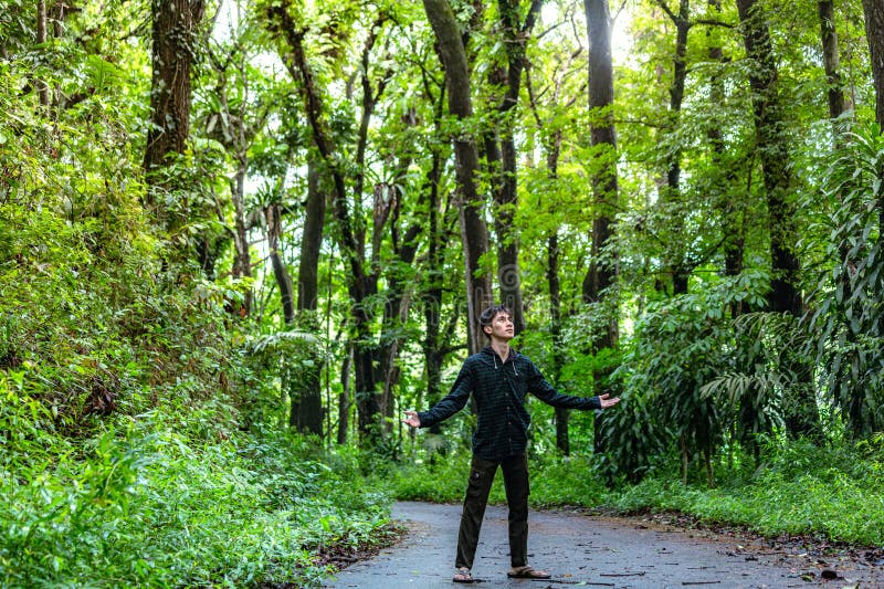 Handsome Man Feel the Nature in Deep Forest. Beautiful Dramatic Deep ...