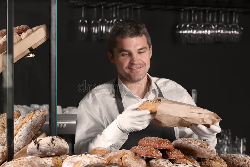 Handsome Man with Freshly Baked Bread Working in Bakery Shop Stock ...