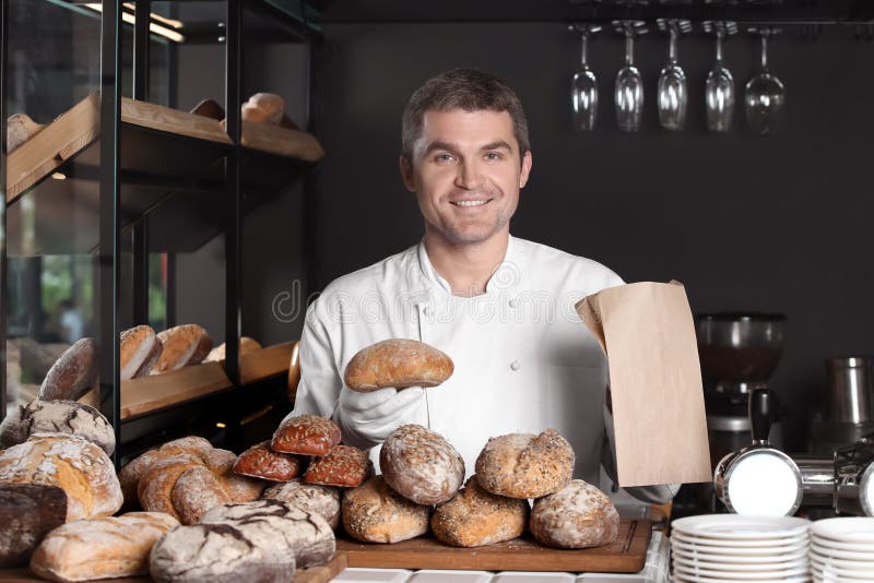 Handsome Man with Freshly Baked Bread Working in Bakery Shop Stock ...