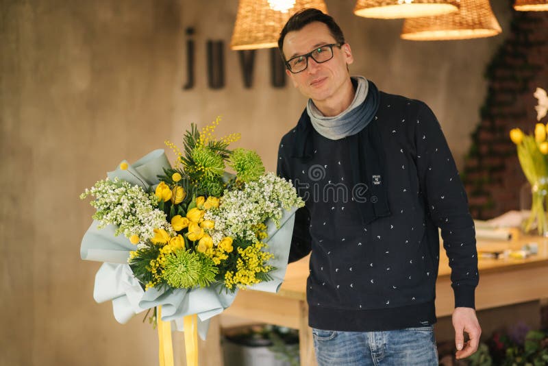 Handsome Man in Glasses Hold Spring Bouquet in Hands Inside. Interior ...